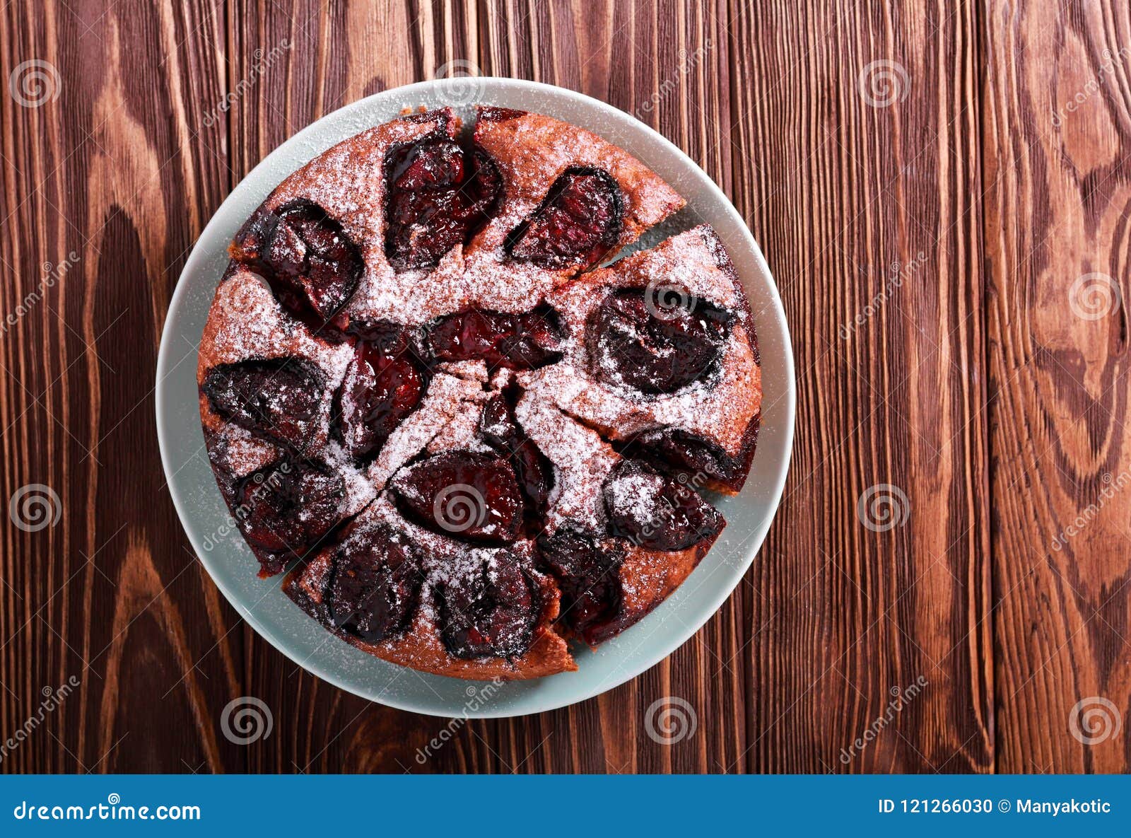 Plum Chocolate Cake with Icing Sugar Over Stock Photo - Image of wooden ...