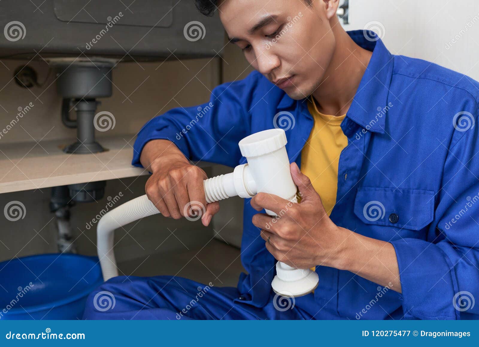 Plumber assembling pipe stock image. Image of renovation - 120275477