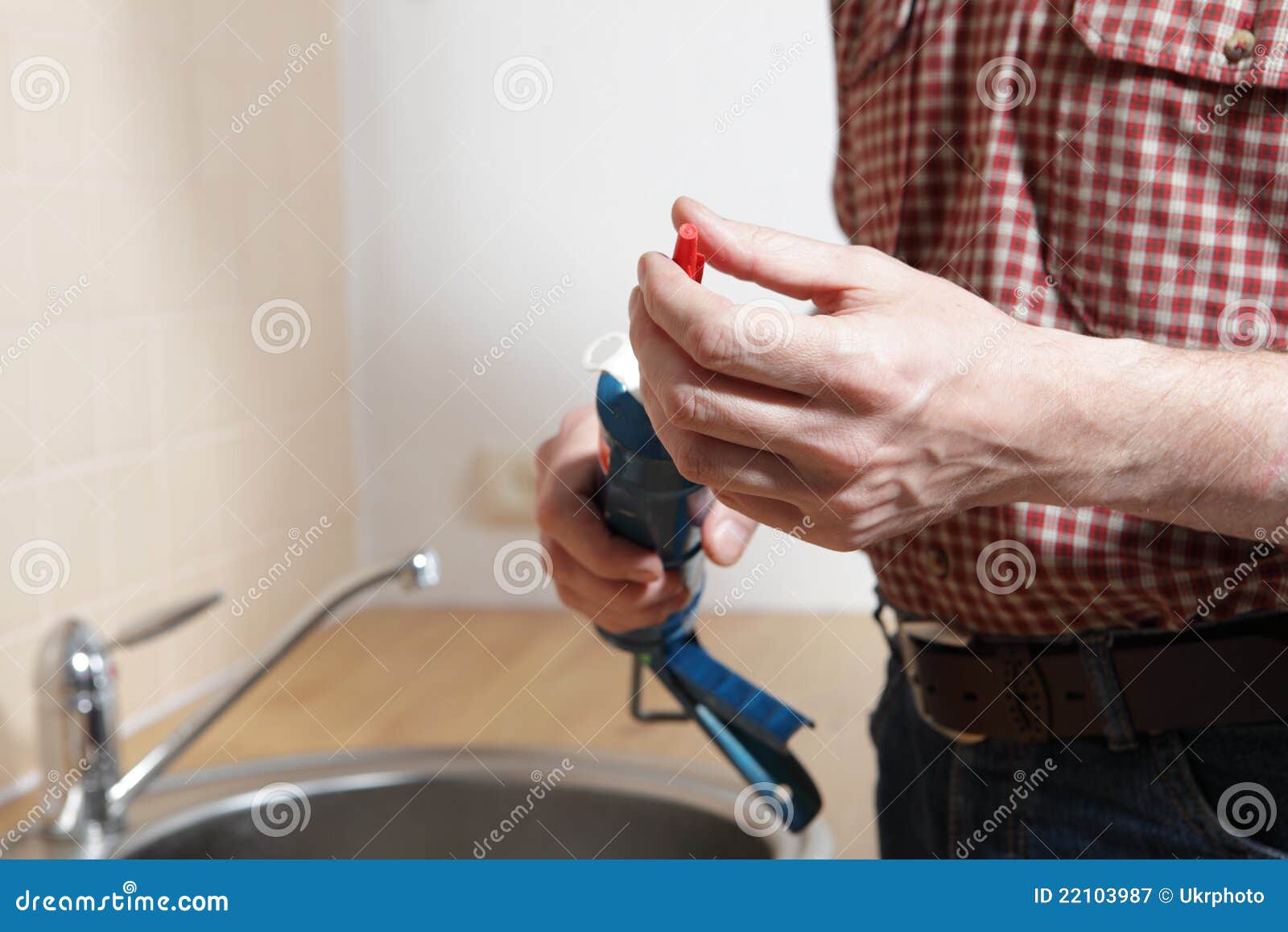 Plumber with caulking gun stock image. Image of sink - 22103987