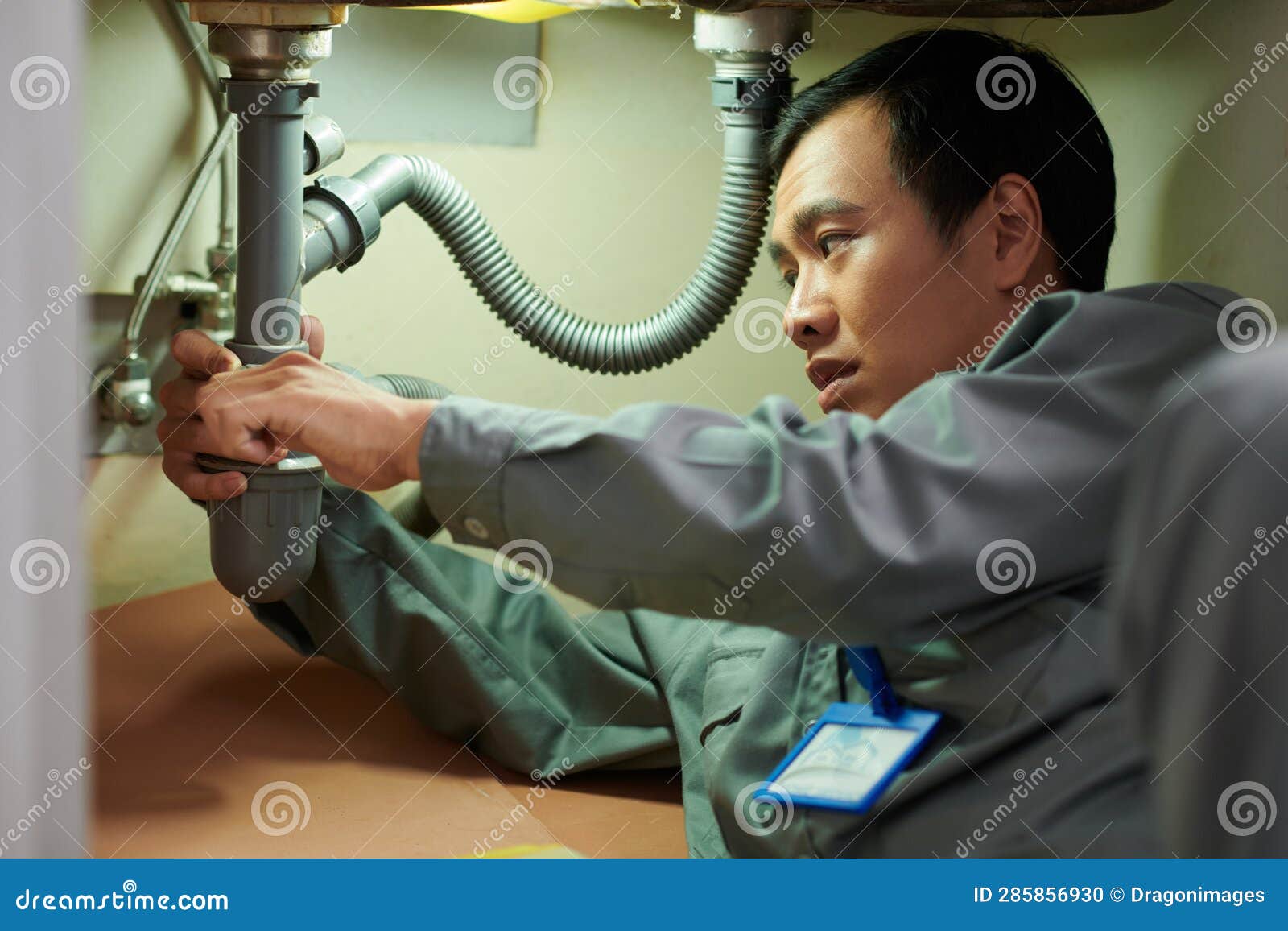 Plumber Cleaning Clogged Pipe Stock Photo - Image of technician, skill ...
