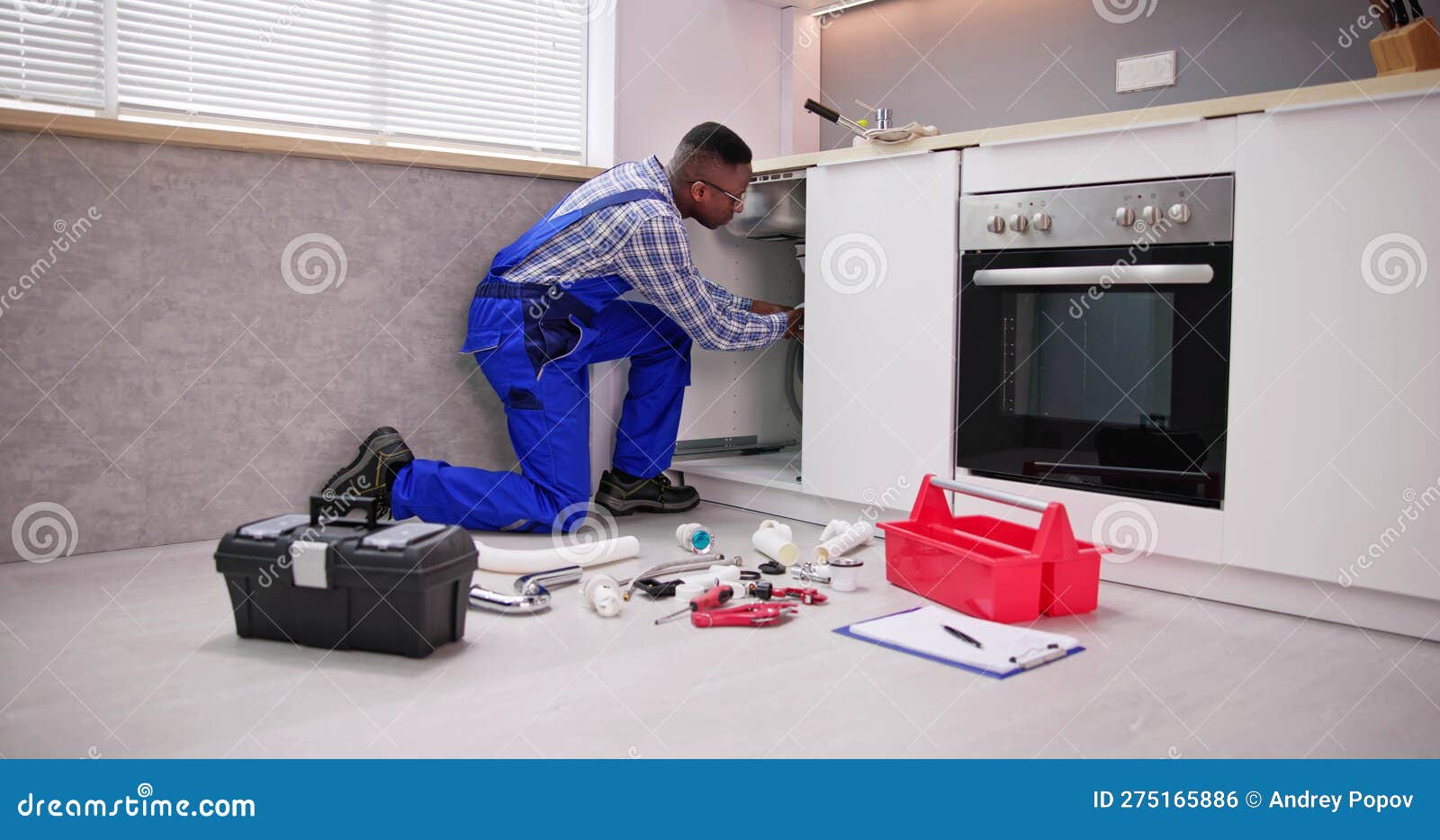Plumber Cleaning Kitchen Drain and Pipe Stock Photo - Image of african ...