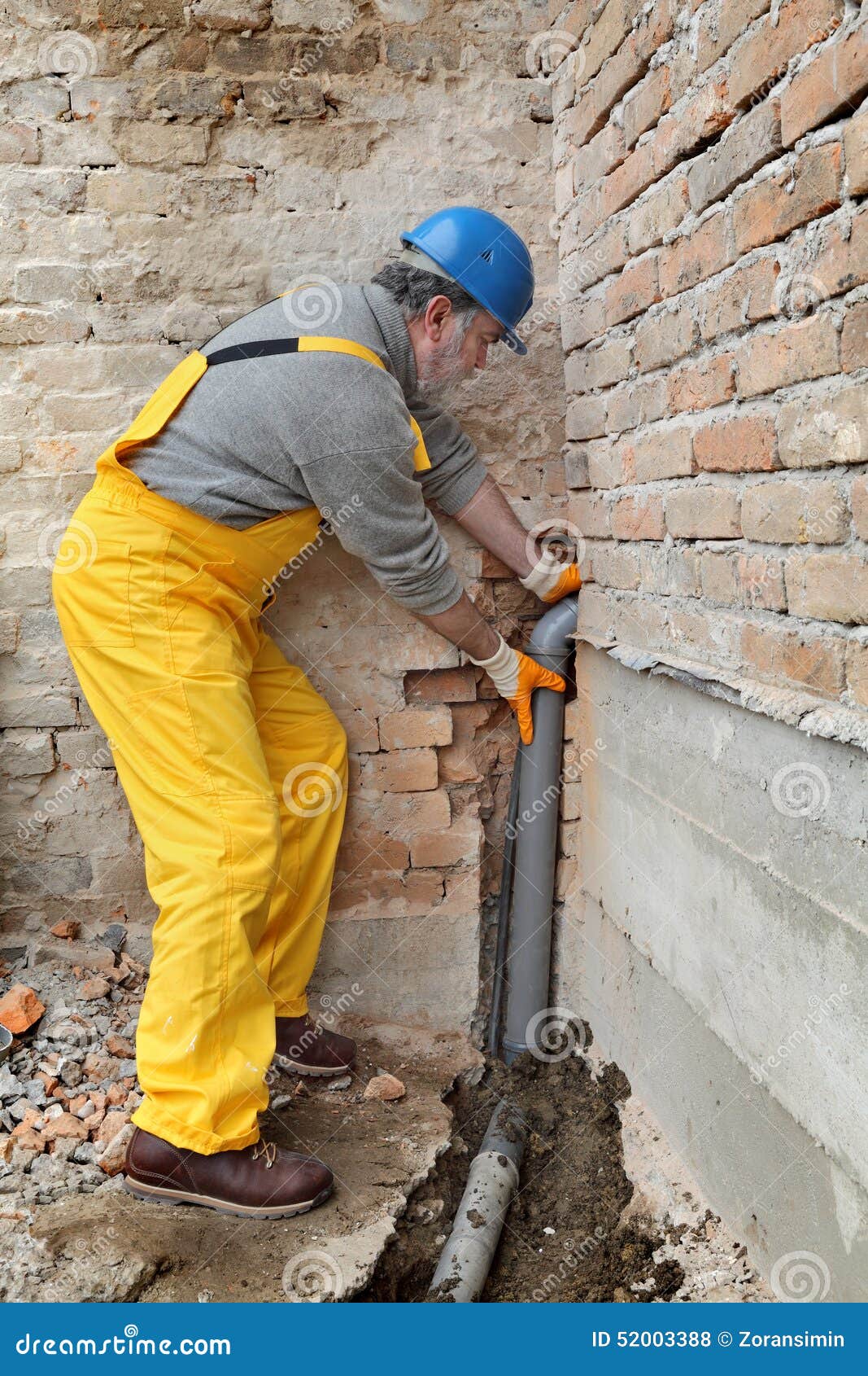 Plumber at Construction Site Installing Sewerage Tube Stock Photo ...
