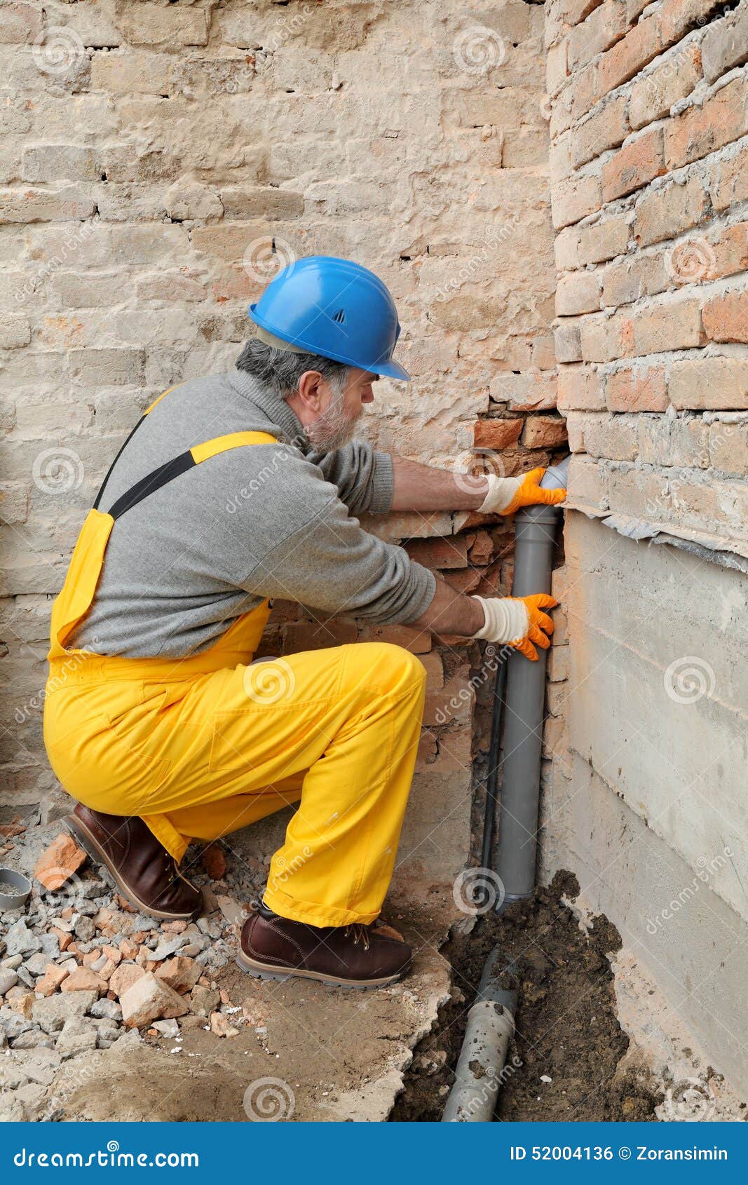 Plumber at Construction Site Installing Sewerage Tube Stock Photo ...