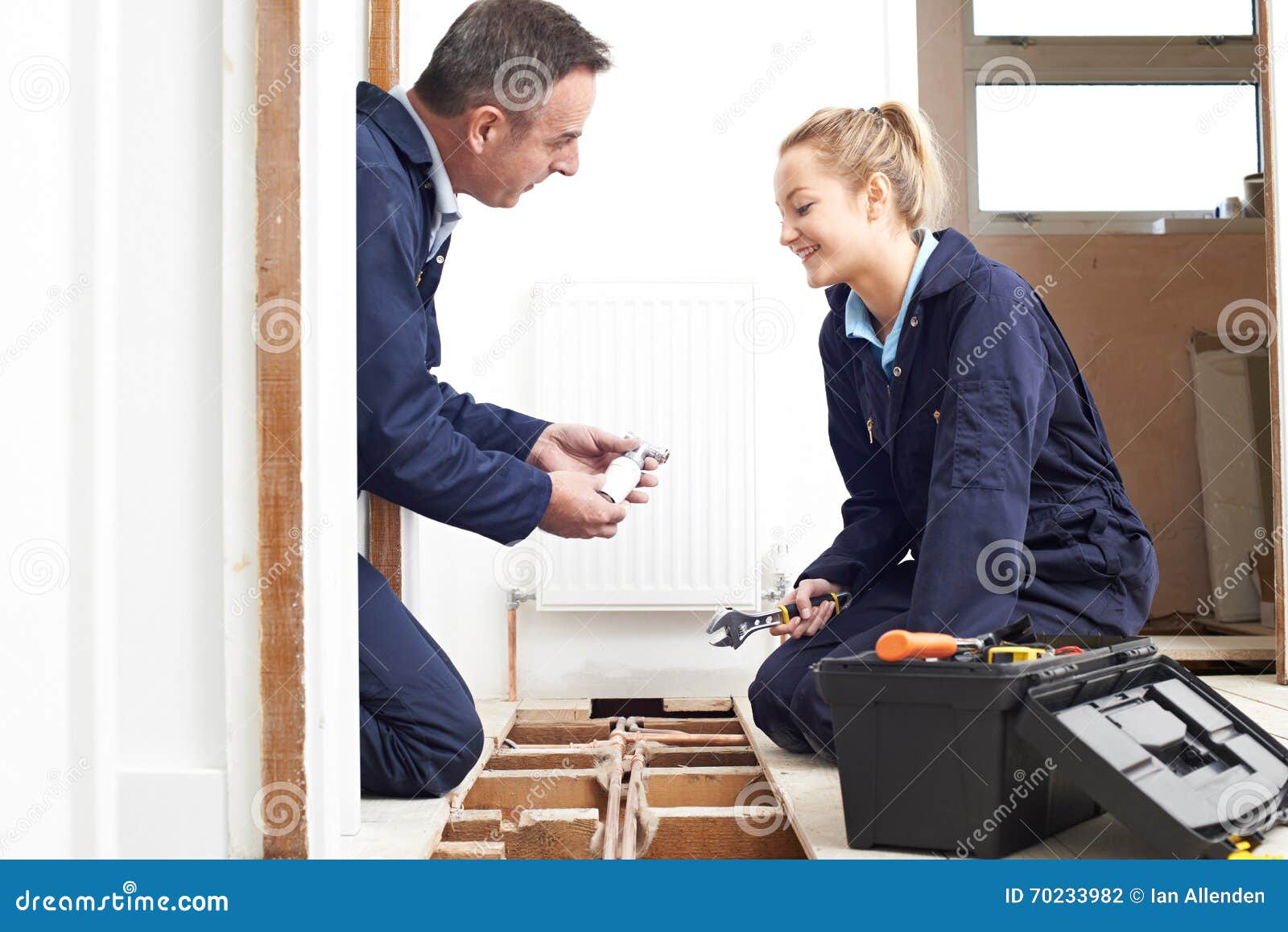 Plumber and Female Apprentice Fitting Central Heating Stock Photo ...
