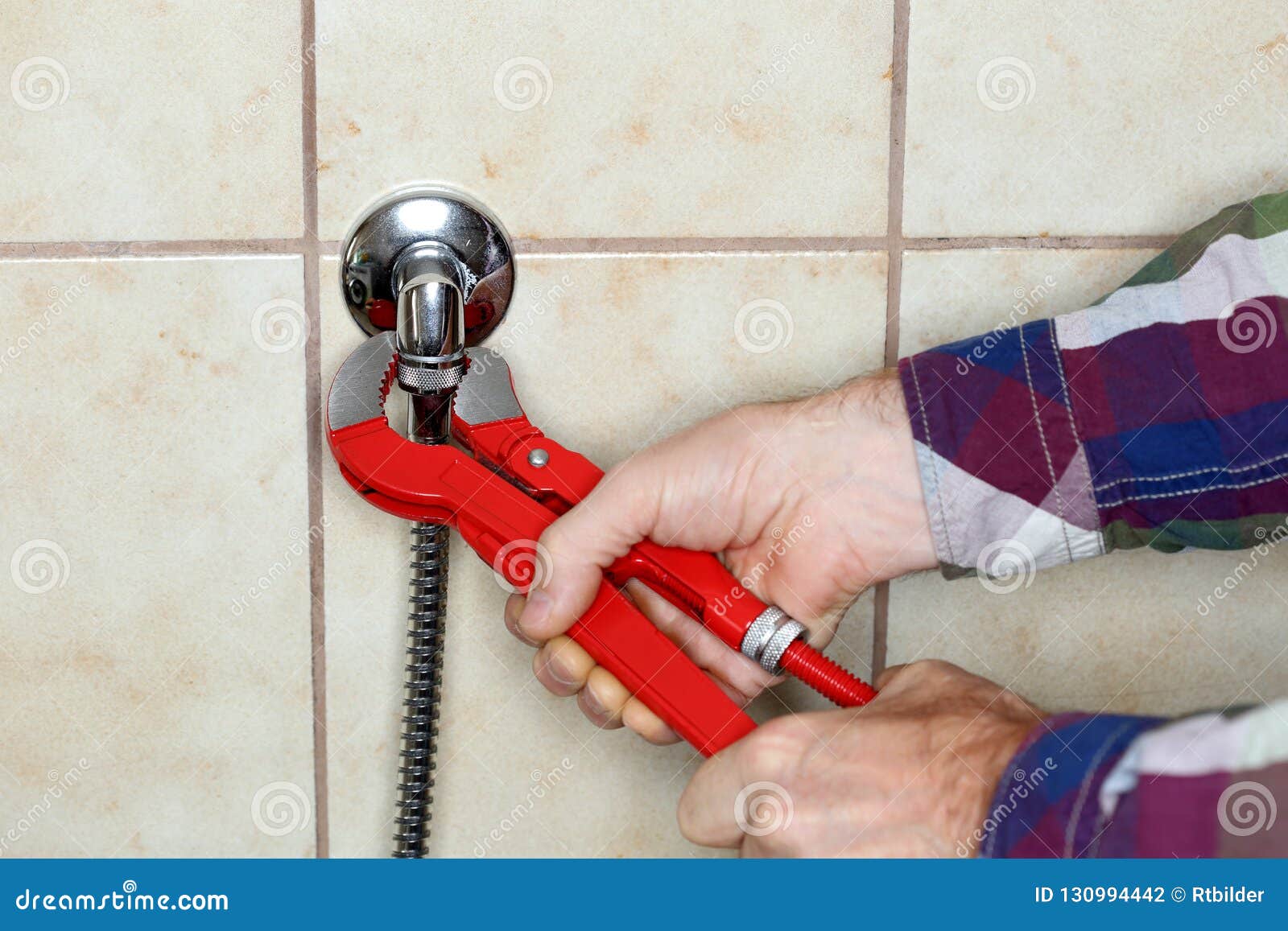 Plumber fixes a pipe stock photo. Image of room, tool - 130994442