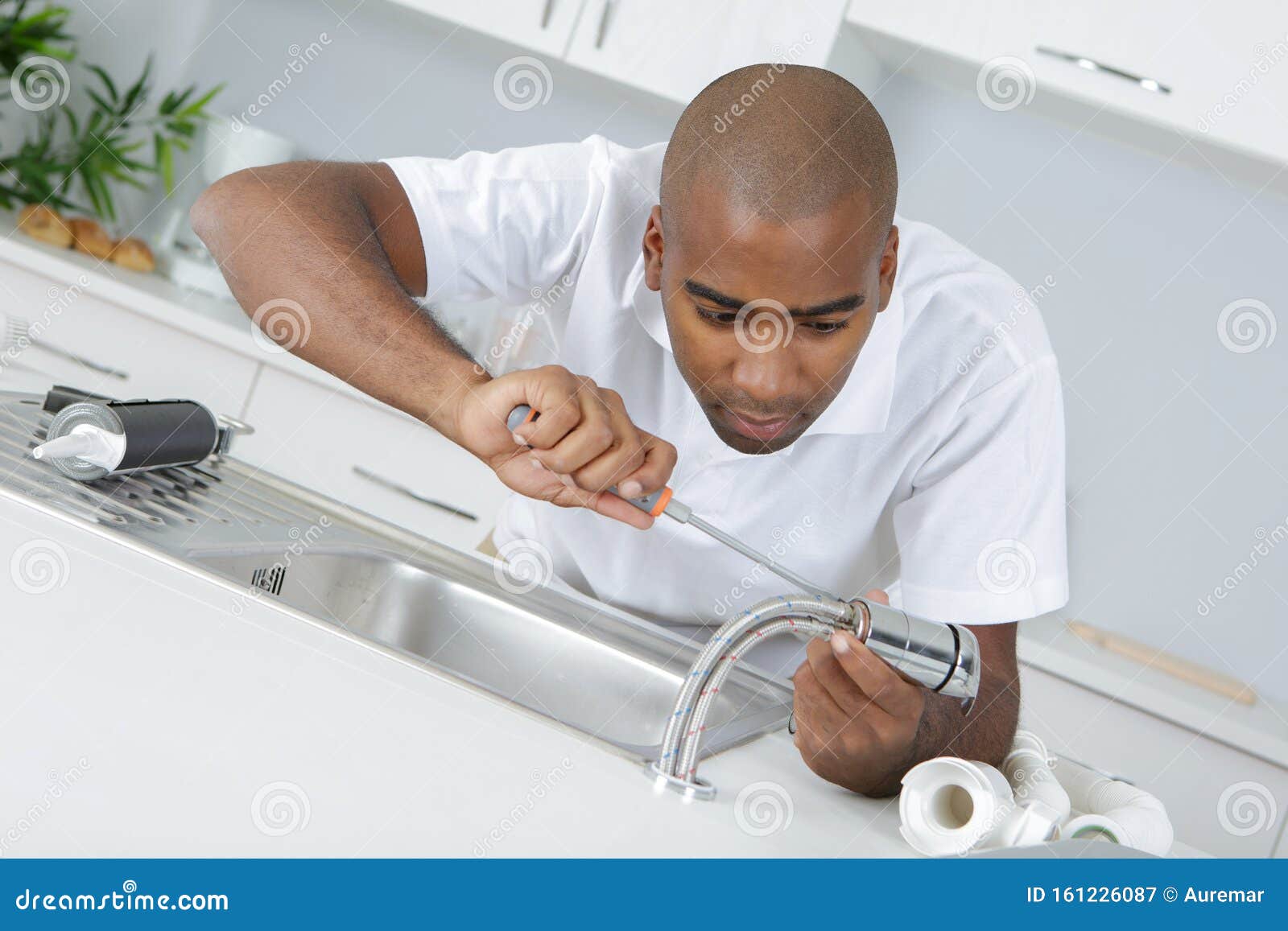 Plumber fixing faucet stock image. Image of pipe, household - 161226087