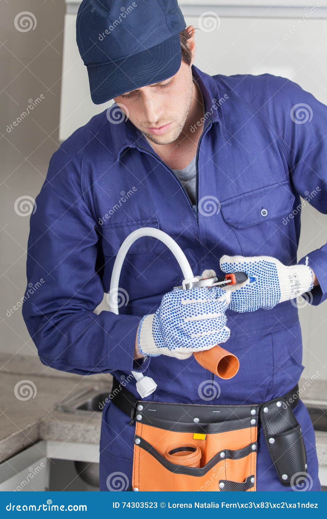 The plumber fixing a pipe stock image. Image of handyman - 74303523