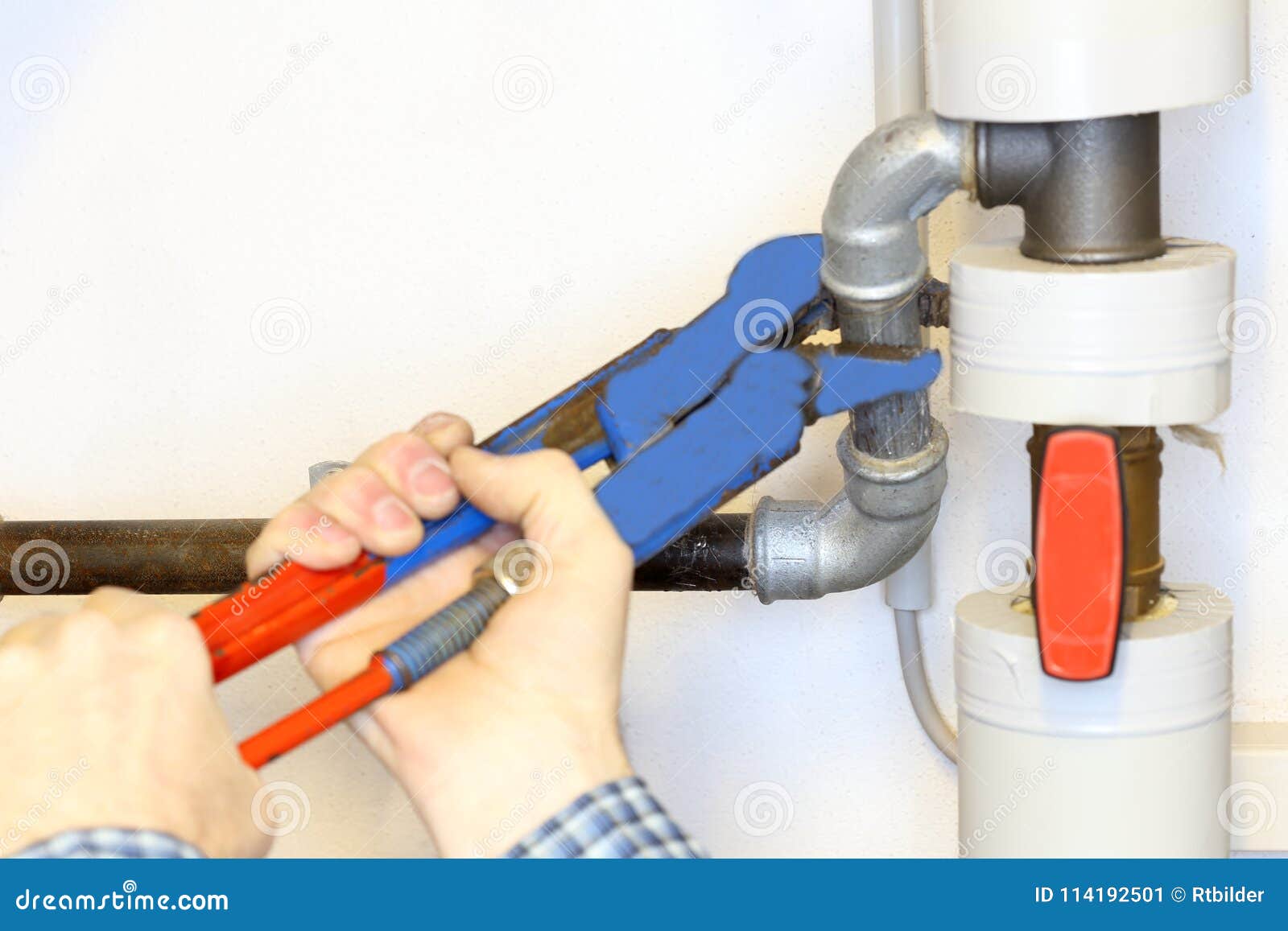 Plumber is fixing a pipe stock image. Image of house - 114192501