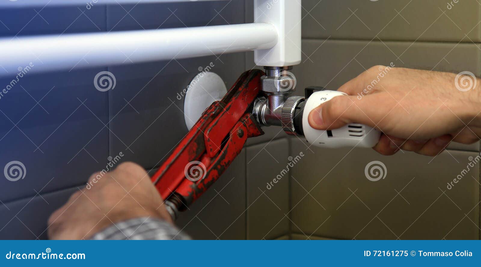 Plumber fixing a radiator stock image. Image of building - 72161275
