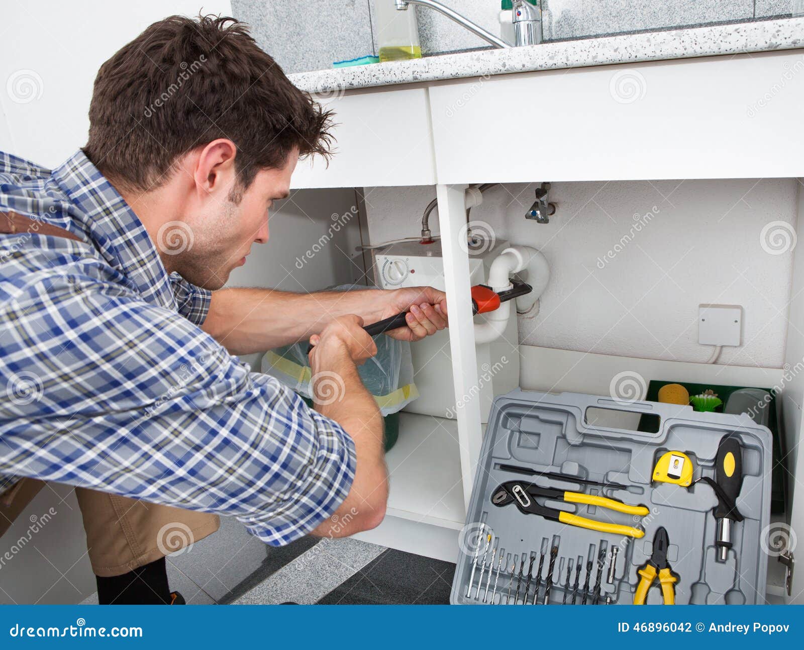 Plumber Fixing Sink in Kitchen Stock Photo - Image of male, drain: 46896042