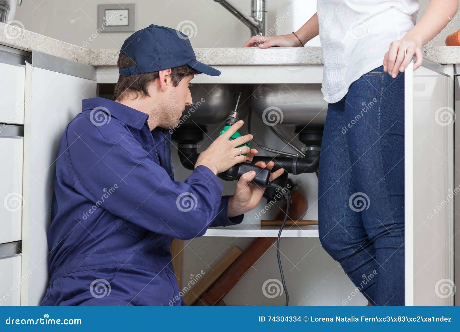 Plumber fixing a sink stock photo. Image of mechanic - 74304334
