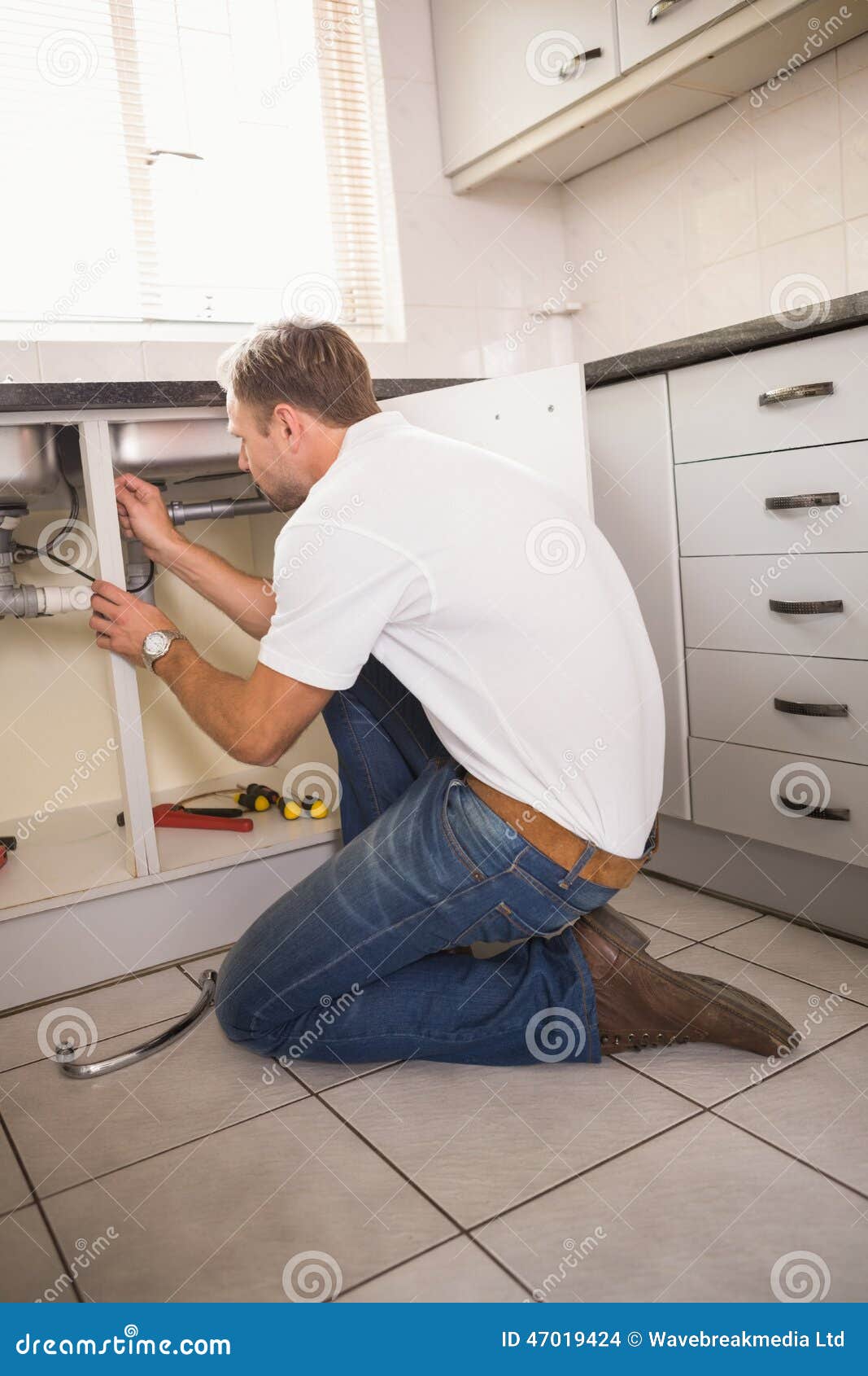 Plumber Fixing Under the Sink Stock Photo - Image of professional ...