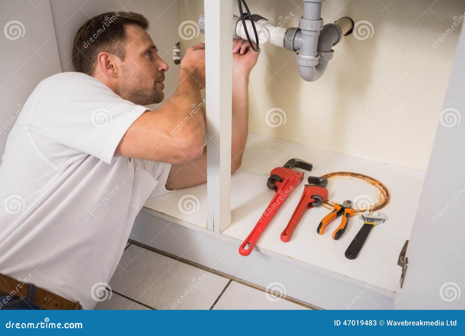 Plumber Fixing Under the Sink Stock Image - Image of handsome, plumber ...