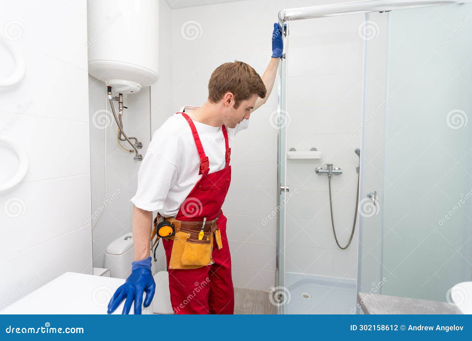 Plumber Installing a Shower Cabin in Bathroom Stock Photo - Image of ...