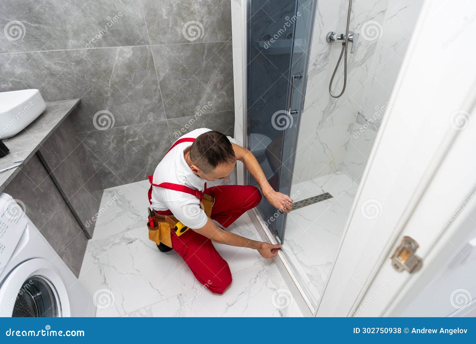 Plumber Installing a Shower Cabin in Bathroom Stock Photo - Image of ...