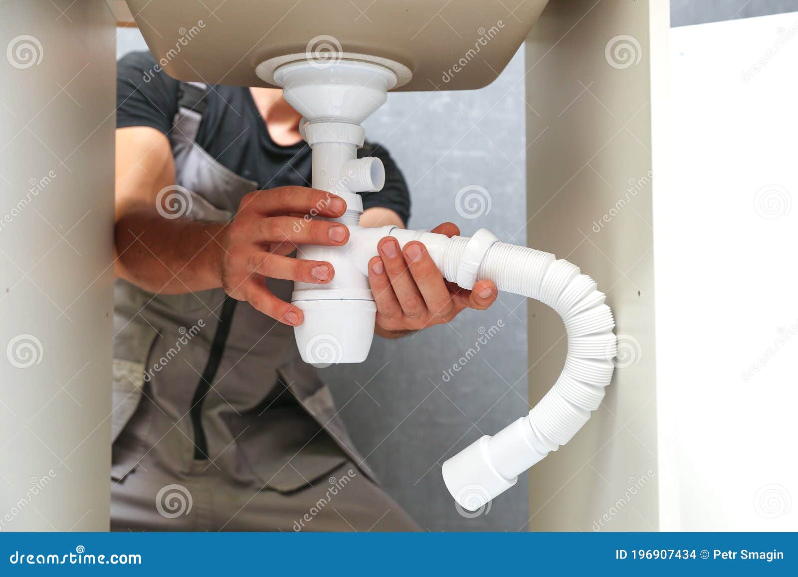 Plumber Installs a Siphon Pipe on the Kitchen Sink. Stock Photo - Image ...