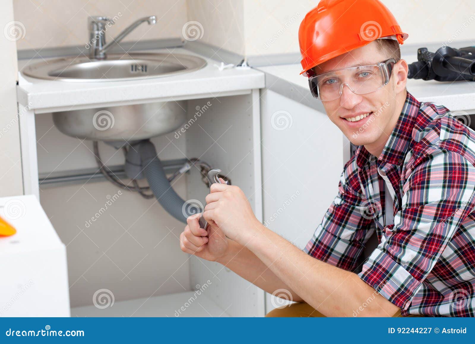 Plumber at the kitchen stock image. Image of industry - 92244227