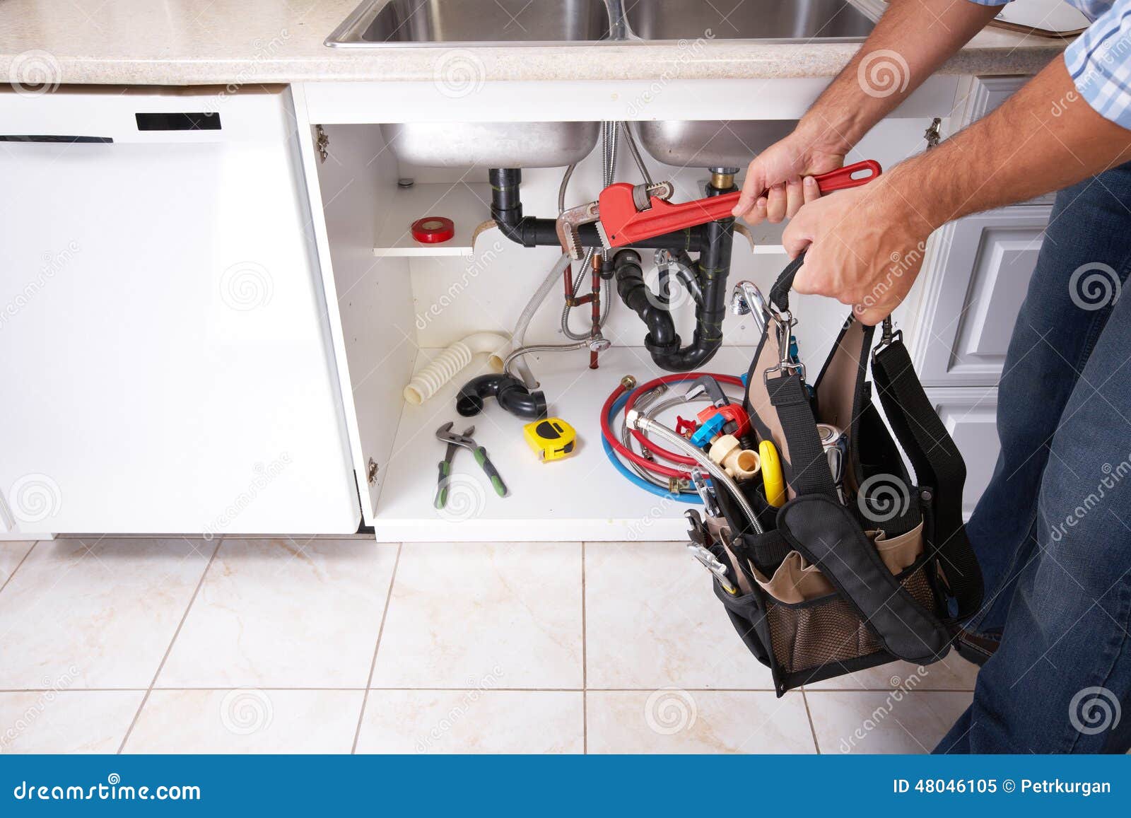 Plumber on the kitchen. stock image. Image of object - 48046105