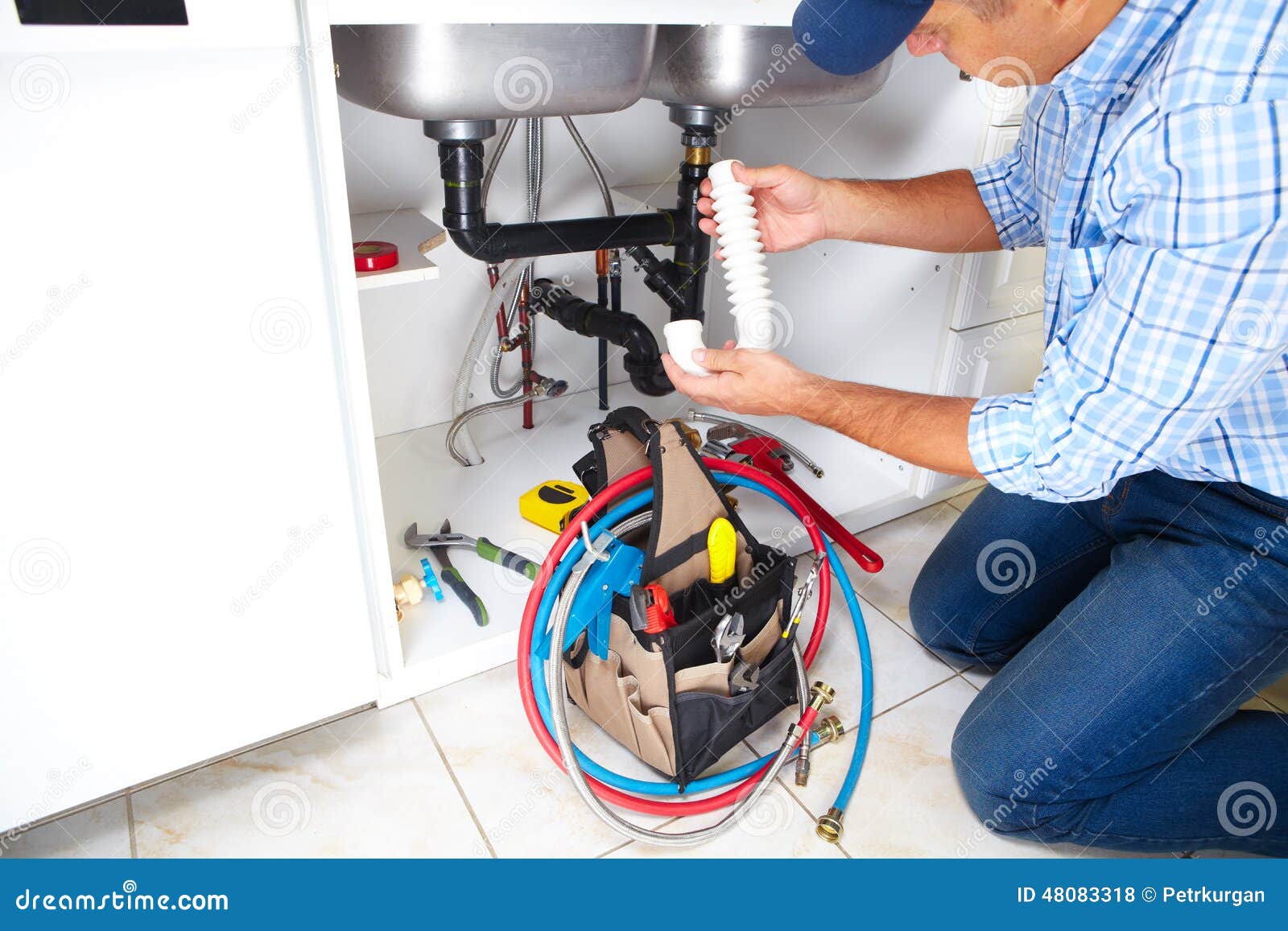 Plumber on the kitchen. stock photo. Image of kitchen - 48083318