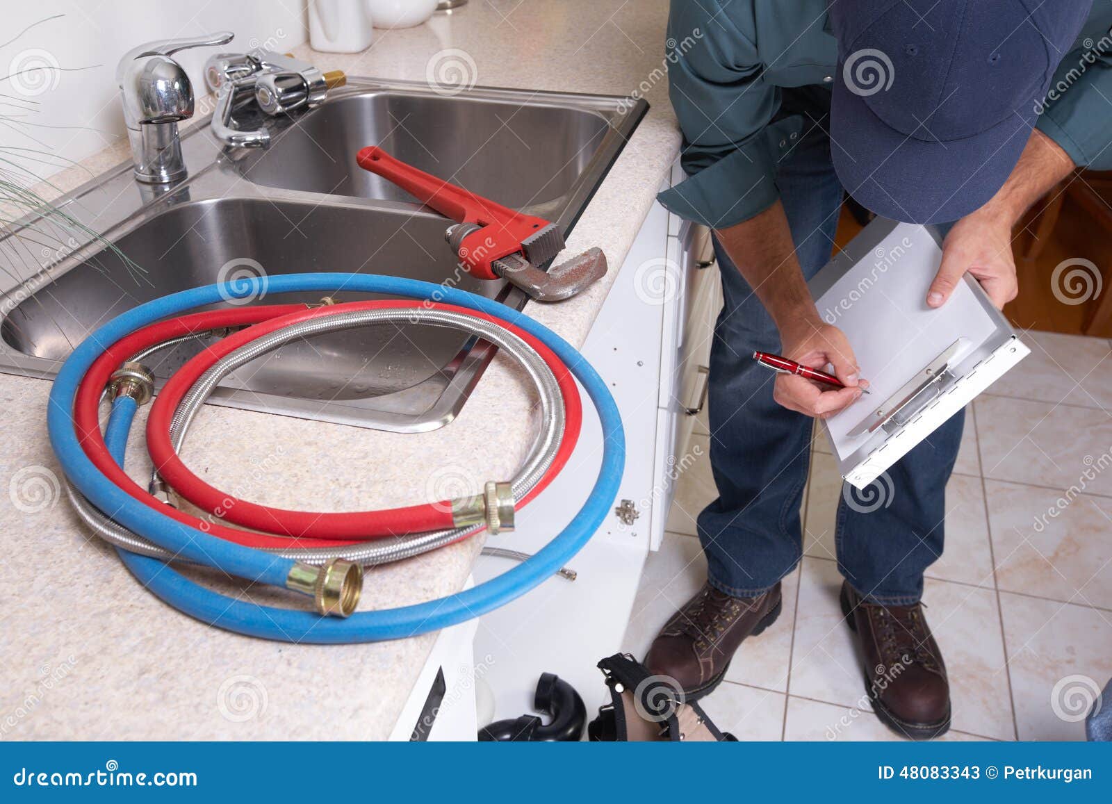 Plumber on the kitchen. stock image. Image of clogged - 48083343