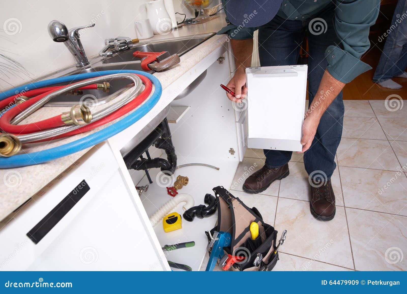 Plumber on the kitchen. stock image. Image of handyman - 64479909