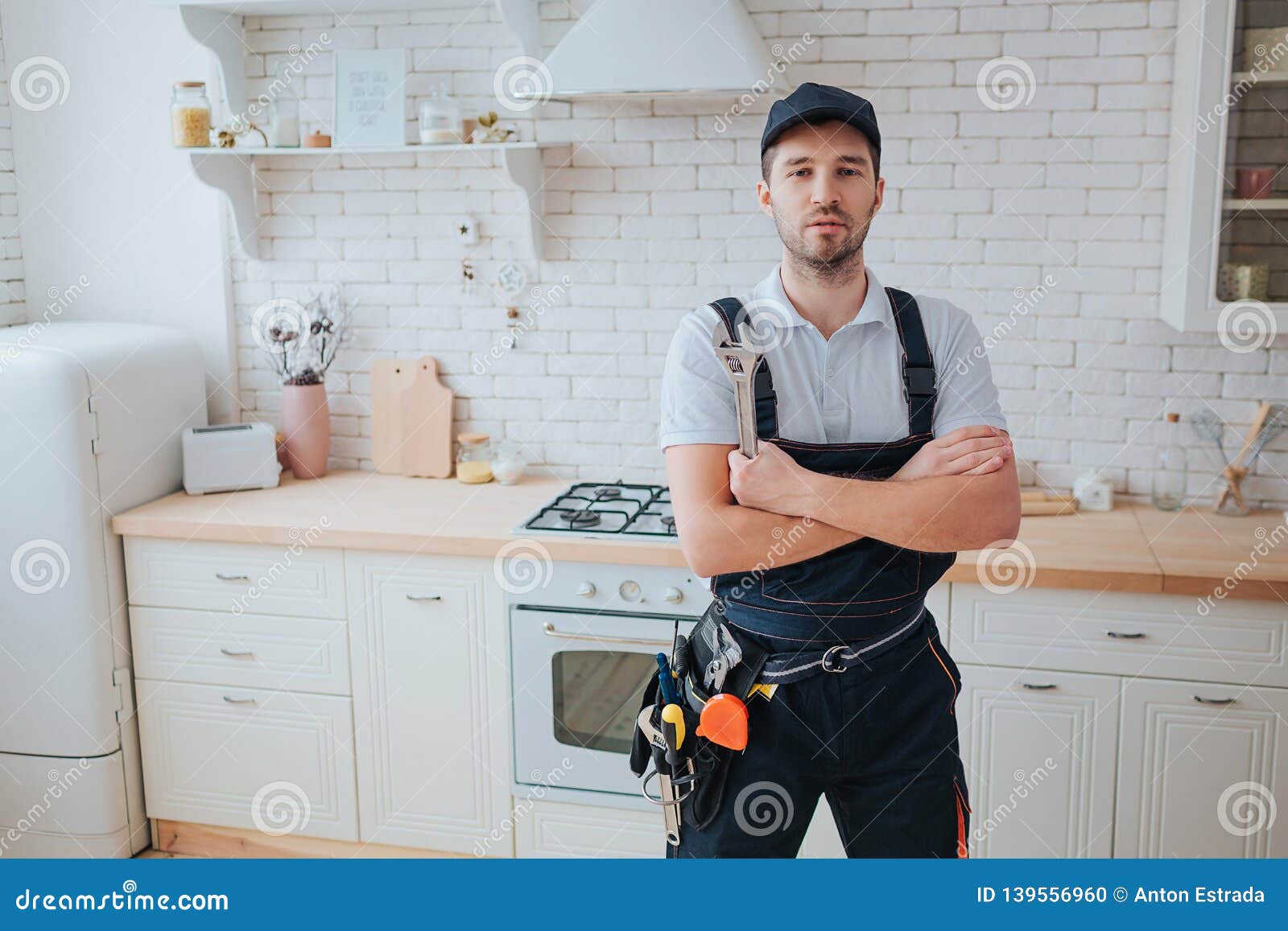 Plumber in Kitchen. Professional Look on Camera and Pose. Hands Crossed ...