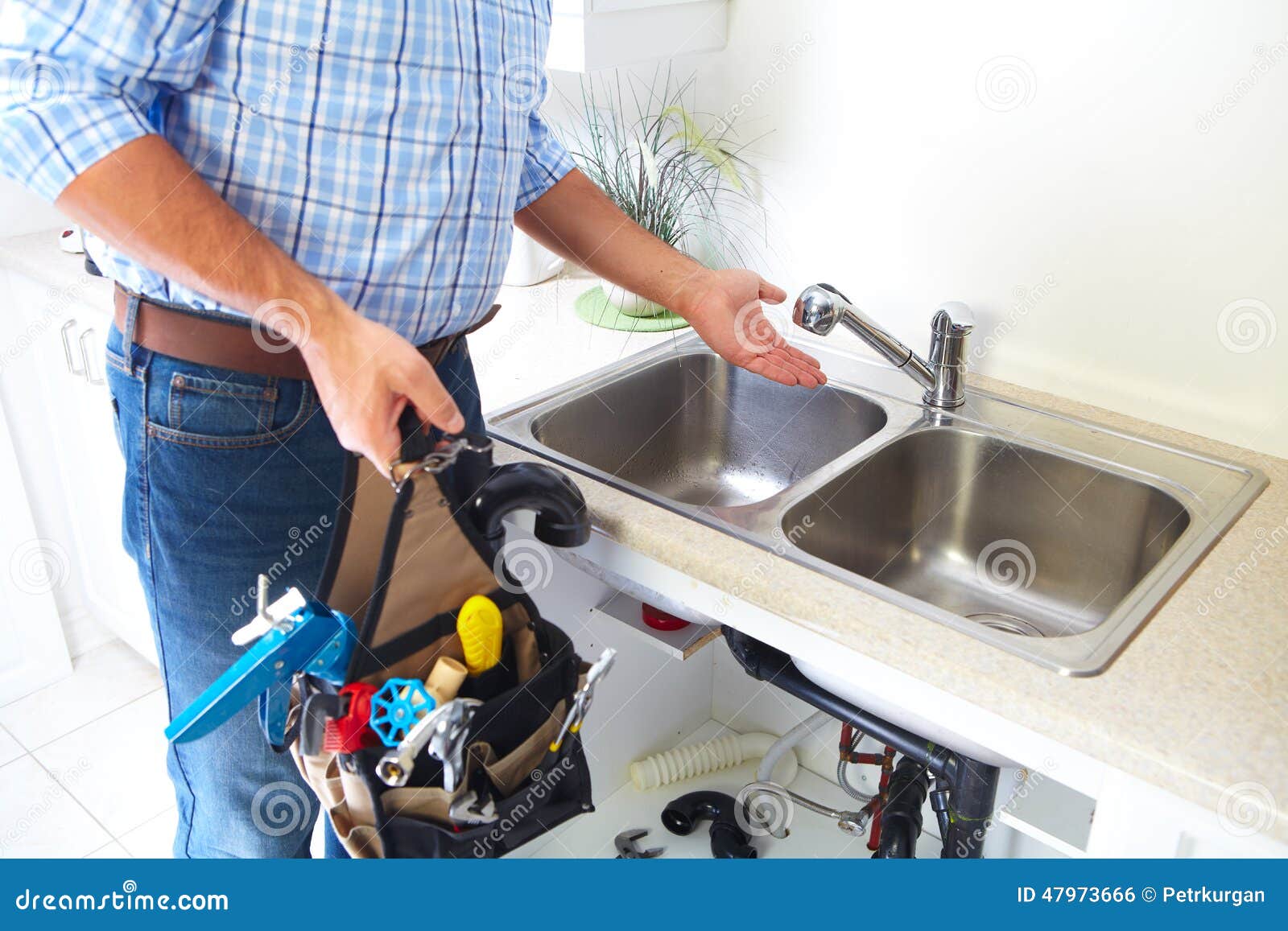 Plumber on the kitchen. stock photo. Image of service - 47973666