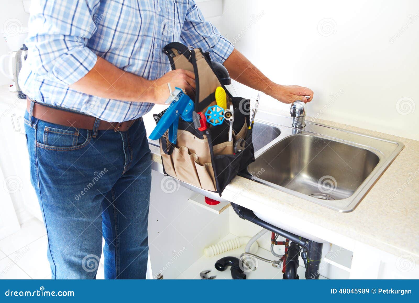 Plumber on the kitchen. stock image. Image of background - 48045989