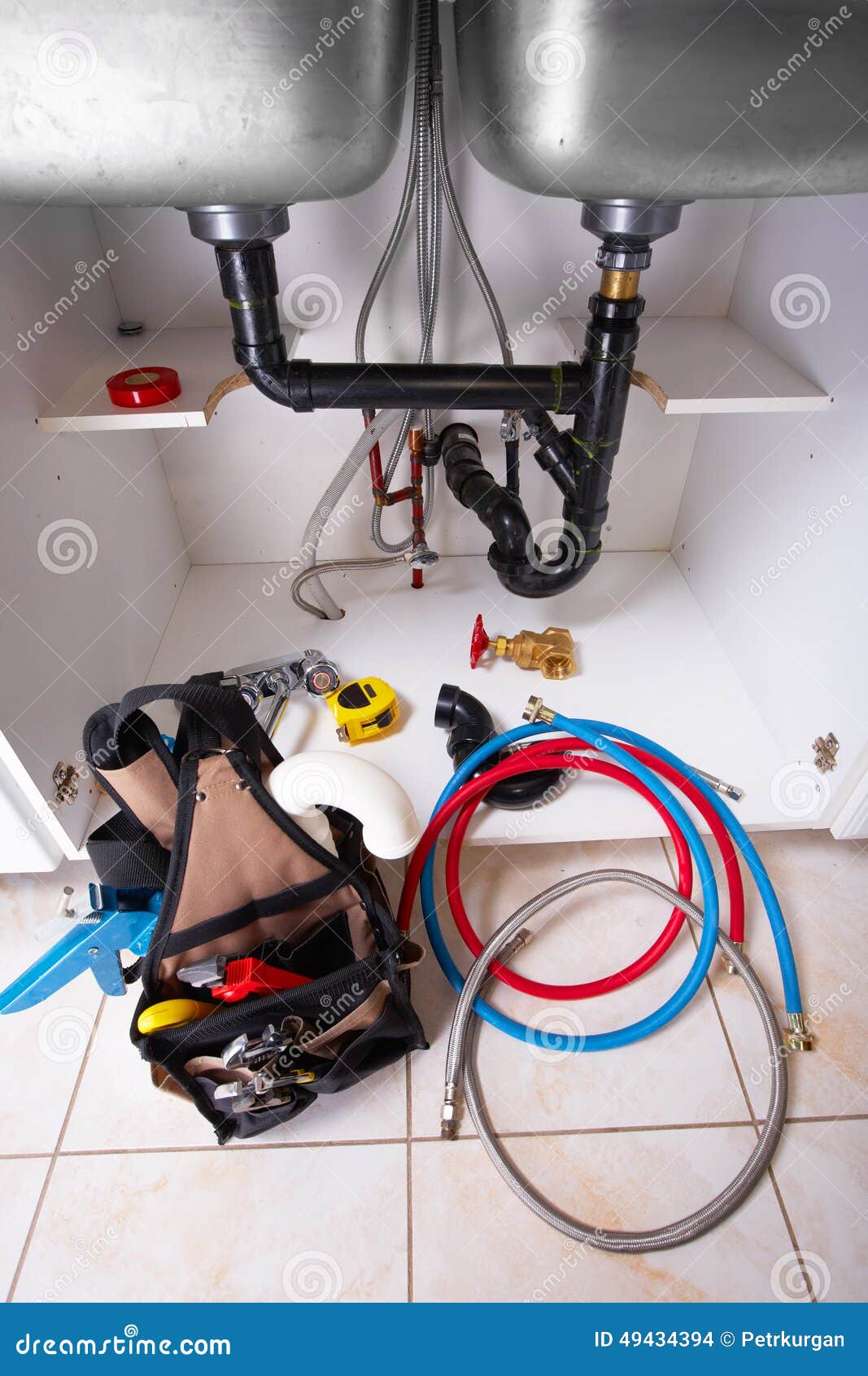 Plumber on the kitchen. stock photo. Image of clog, service - 49434394
