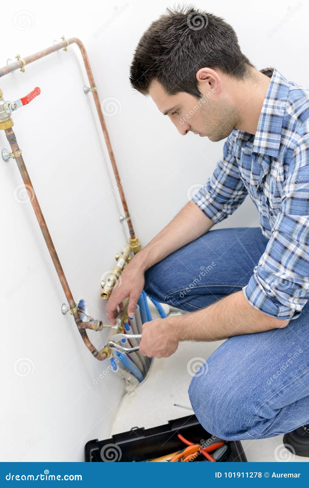 Plumber Making Adjustments To Heating System Stock Photo - Image of ...