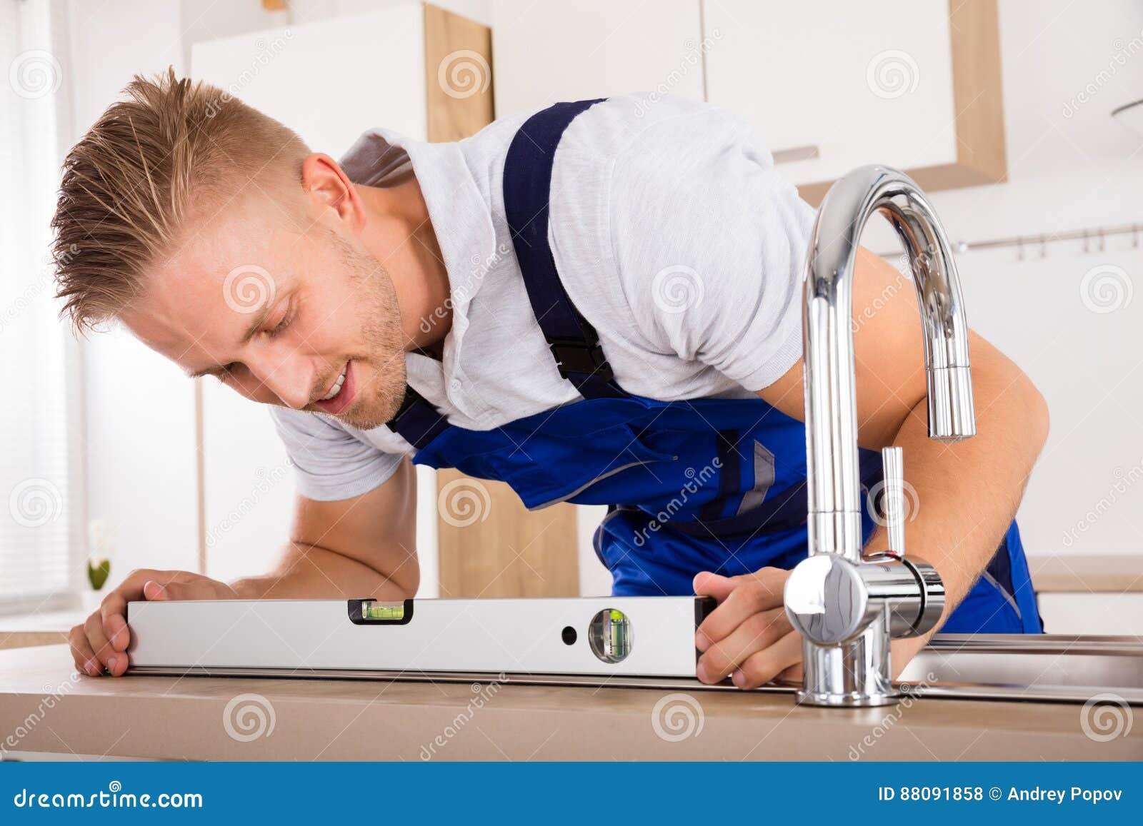 Plumber Measuring Level of a Sink Stock Photo - Image of person ...