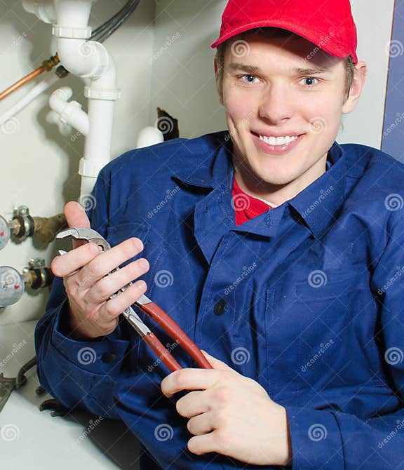 Plumber in uniform stock photo. Image of happy, holding - 29235108