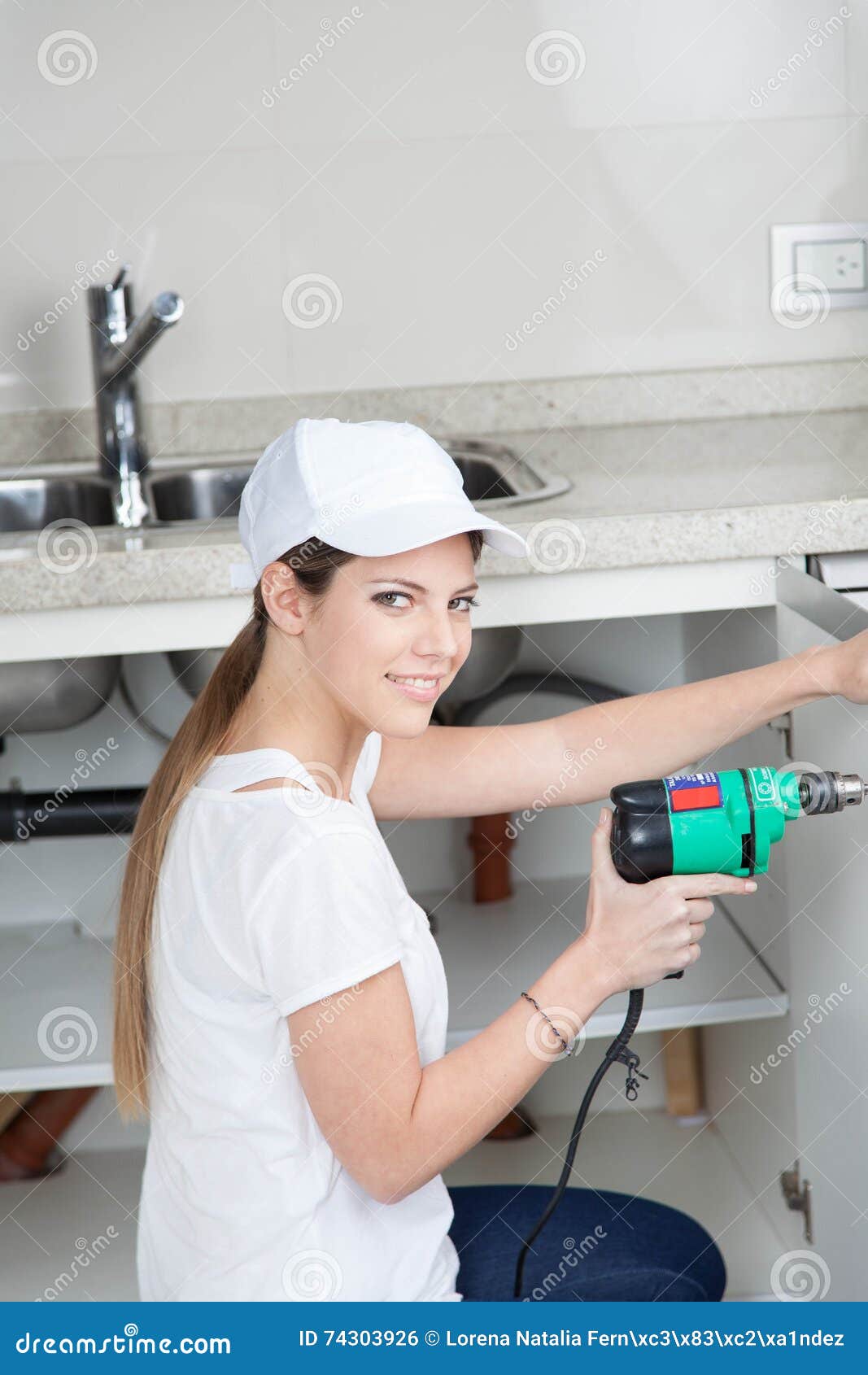 Plumber using the drill stock photo. Image of service - 74303926
