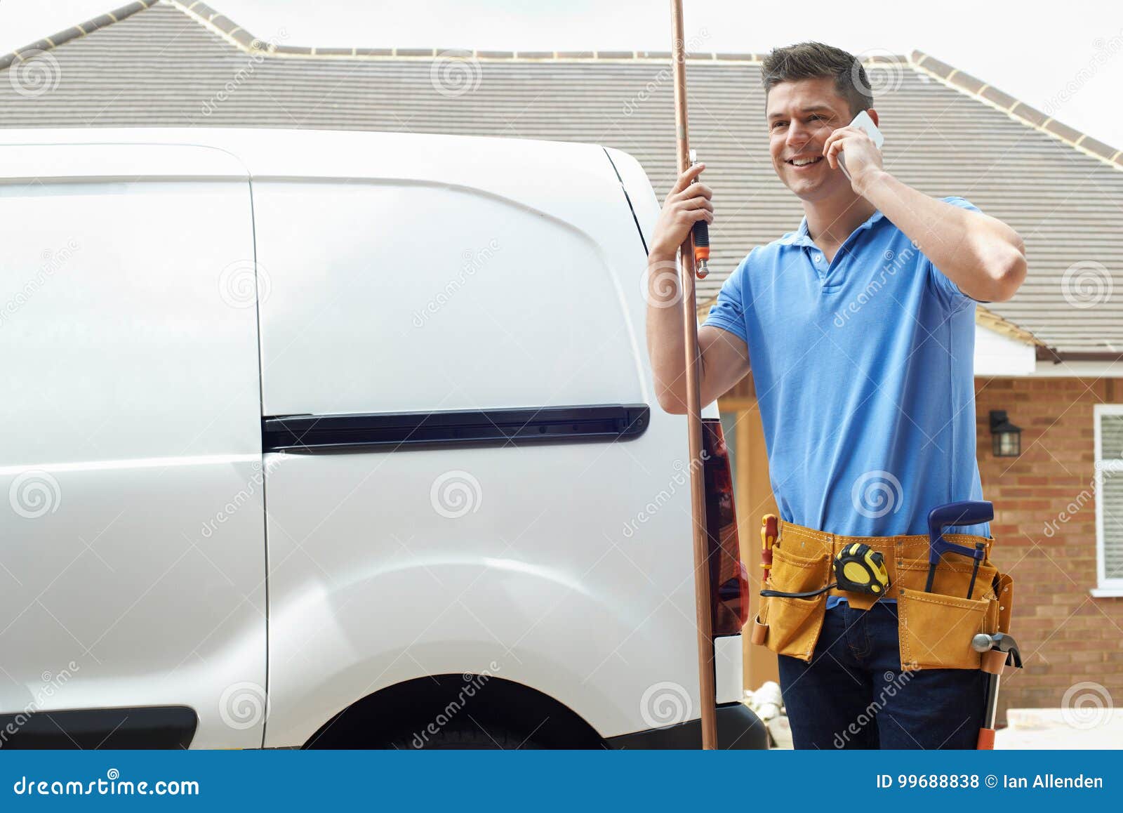 Plumber with Van Making Call on Mobile Phone Outside House Stock Photo ...
