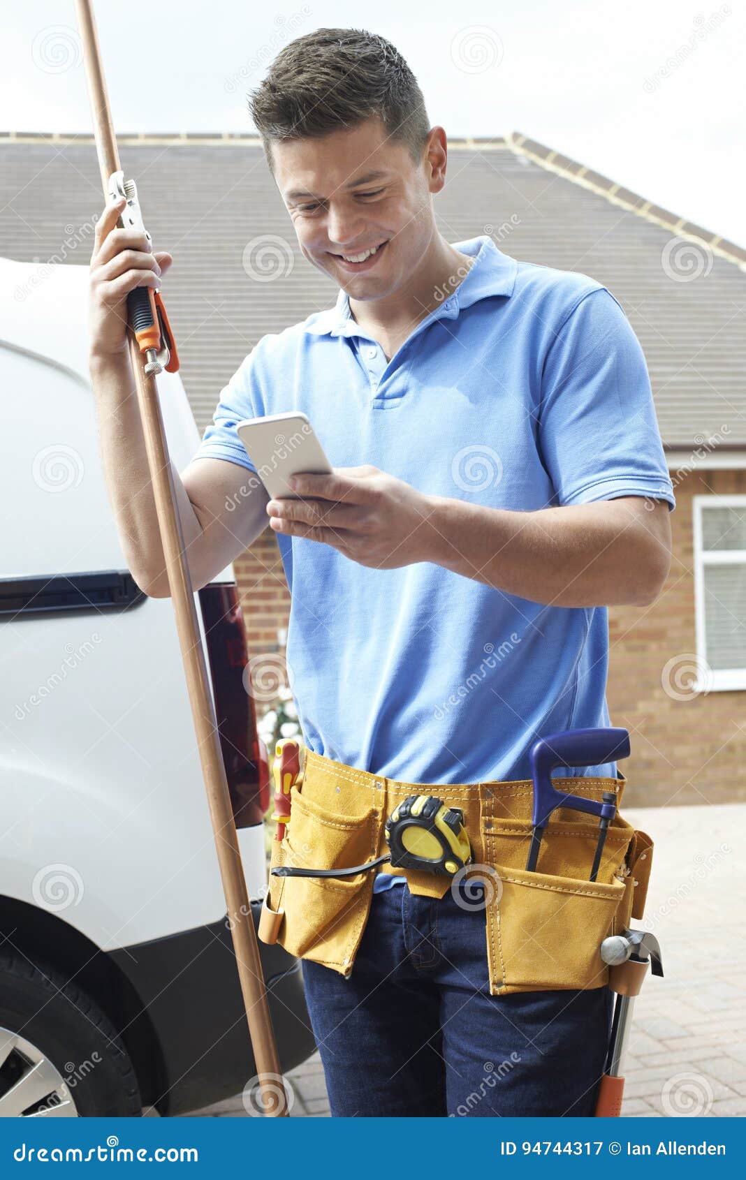 Plumber with Van Texting on Mobile Phone Outside House Stock Image ...