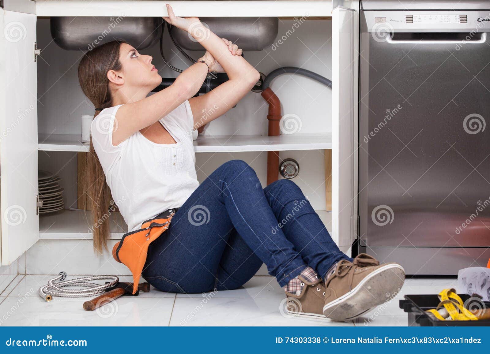 Plumber Woman Repairing De Pipe of the Kitchen Stock Photo - Image of ...