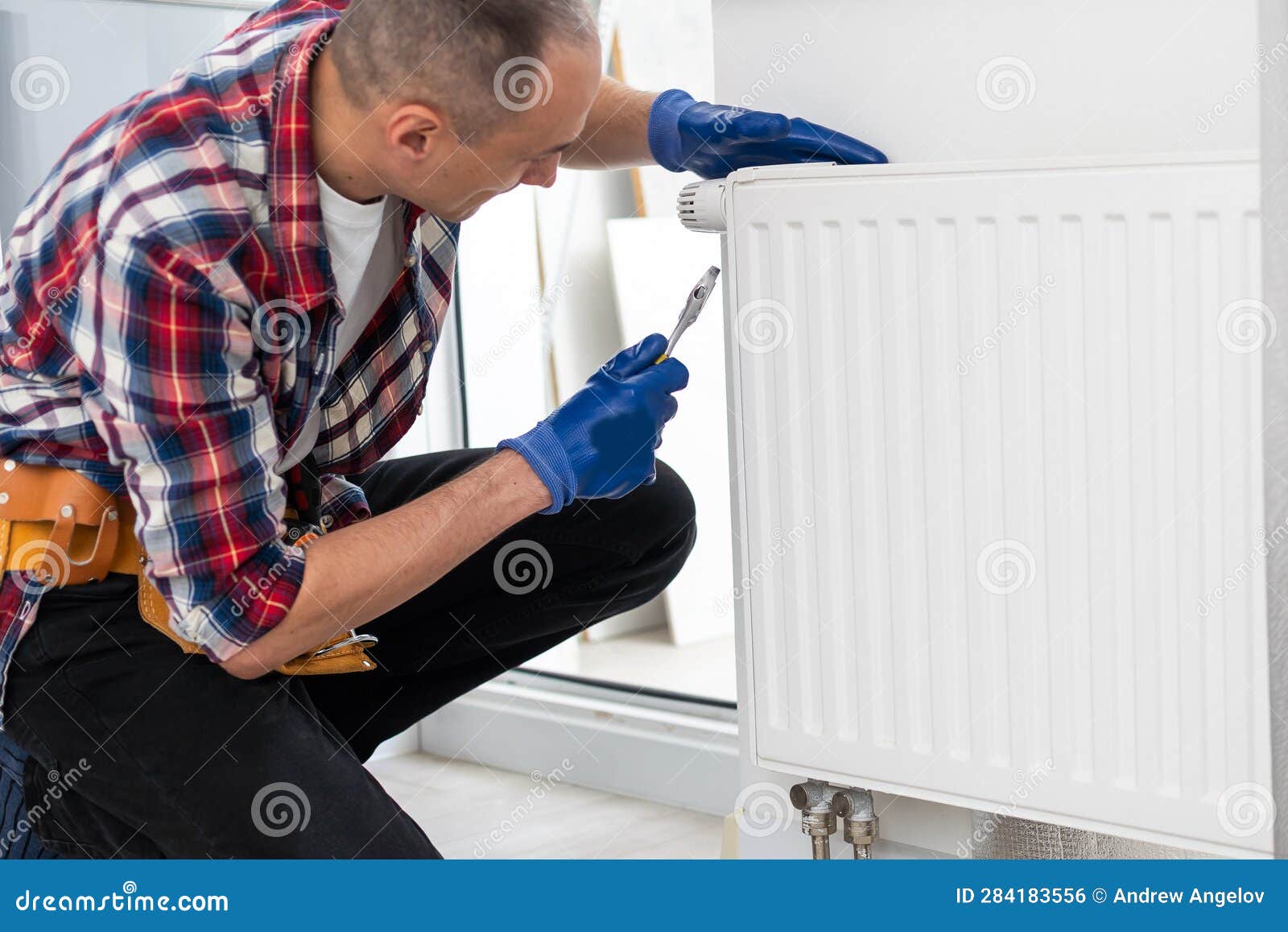 Plumber at Work. Installing Water Heating Radiator Stock Photo - Image ...