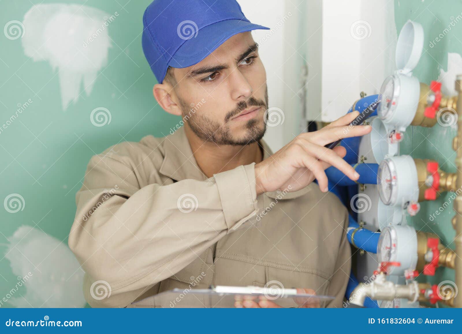 Plumber at Work Installing Water Meter Stock Photo - Image of green ... Plumber at Work Installing Water Meter Stock Photo - Image of green ...