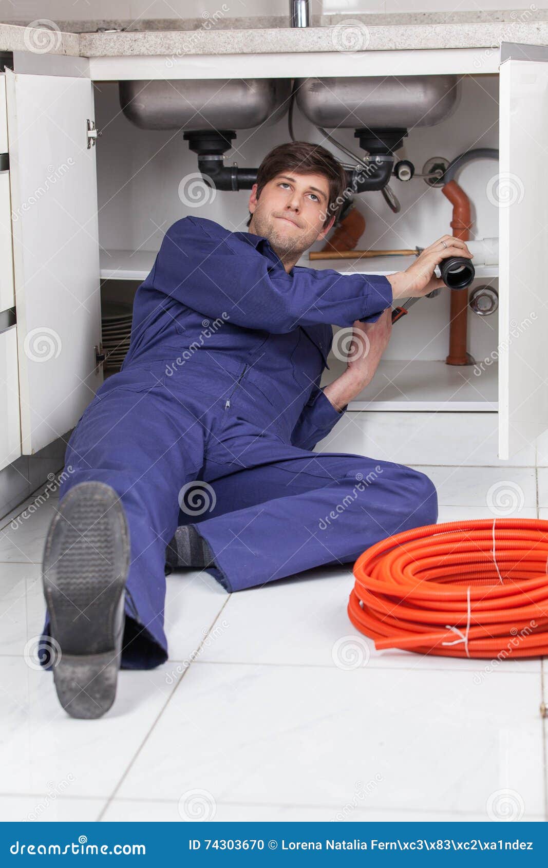 Plumber working hard stock photo. Image of repairman - 74303670