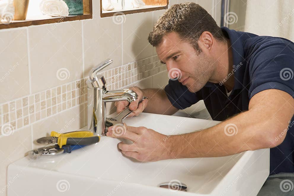 Plumber working on sink stock photo. Image of self, caucasian - 5940964