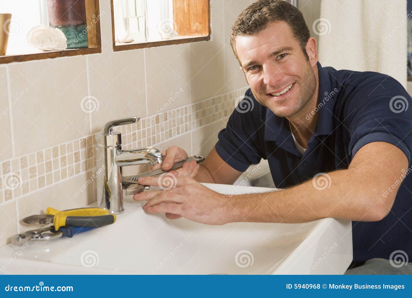 Plumber Working on Sink Smiling Stock Photo - Image of person, bathroom ...