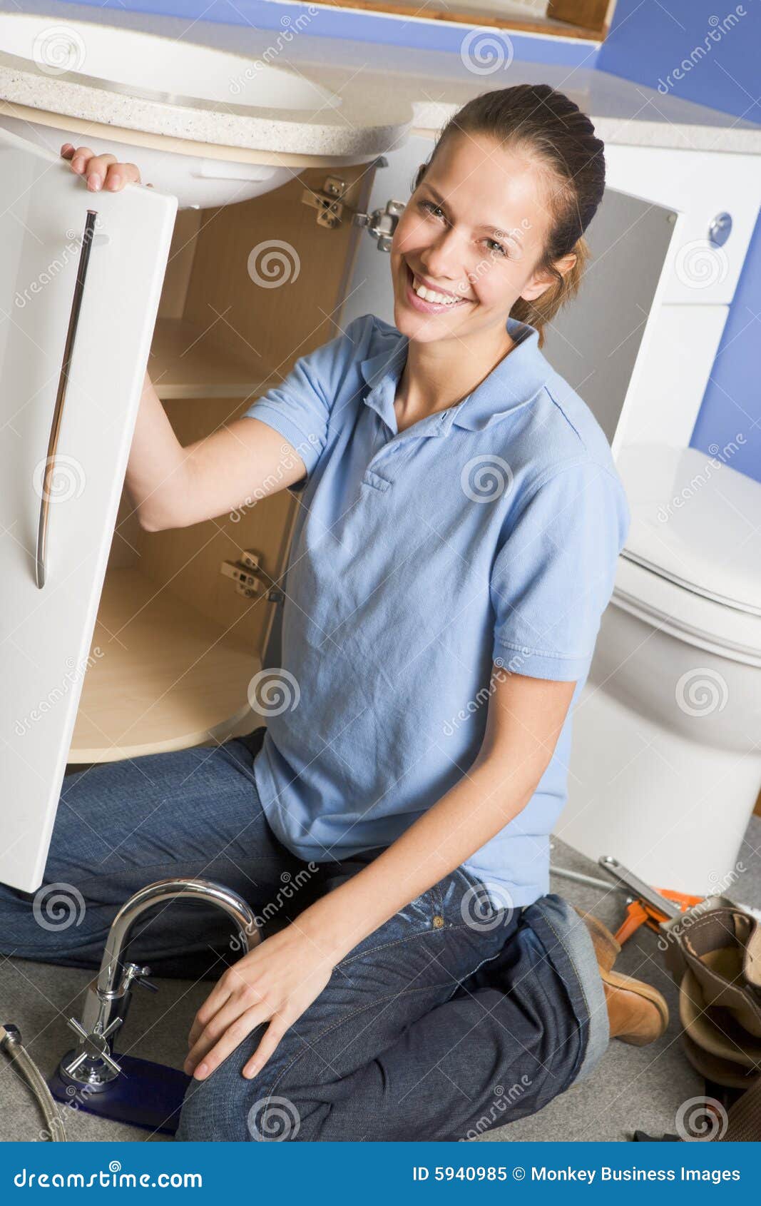Plumber Working on Sink Smiling Stock Image - Image of plumber, holding ...