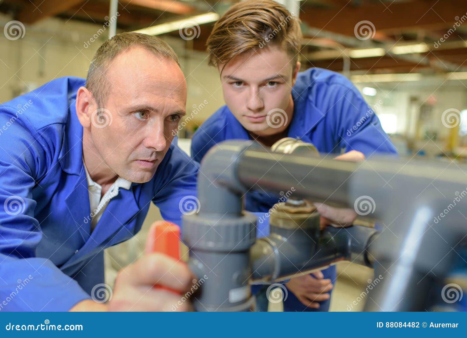 Plumbers checking on tubes stock photo. Image of sewer - 88084482