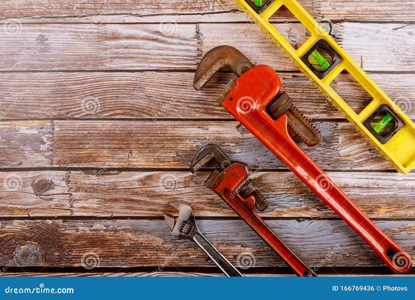 Set Plumbing Adjustable Wrench with Construction Level on Wooden Board ...