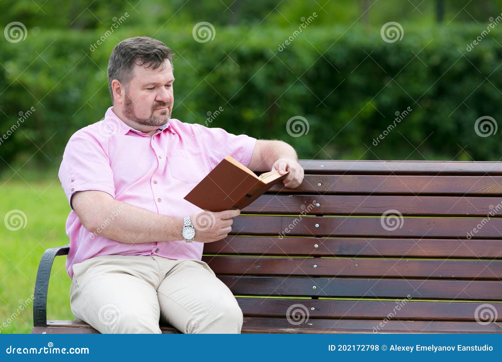 A Plump Man is Reading a Book on the Bench. Stock Photo - Image of ...