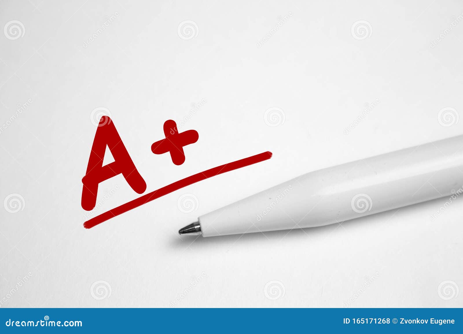 A Plus a Grade Written in Red Pen on Notebook Paper. Stock Photo ...