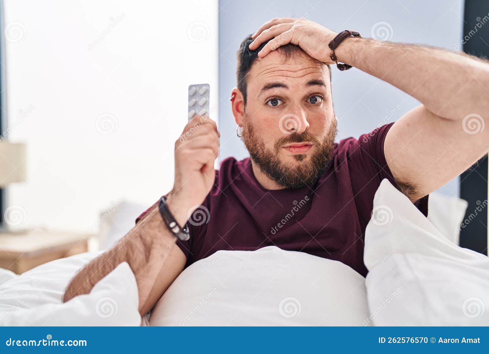 Plus Size Hispanic Man with Beard in the Bed Holding Pills Stressed and ...