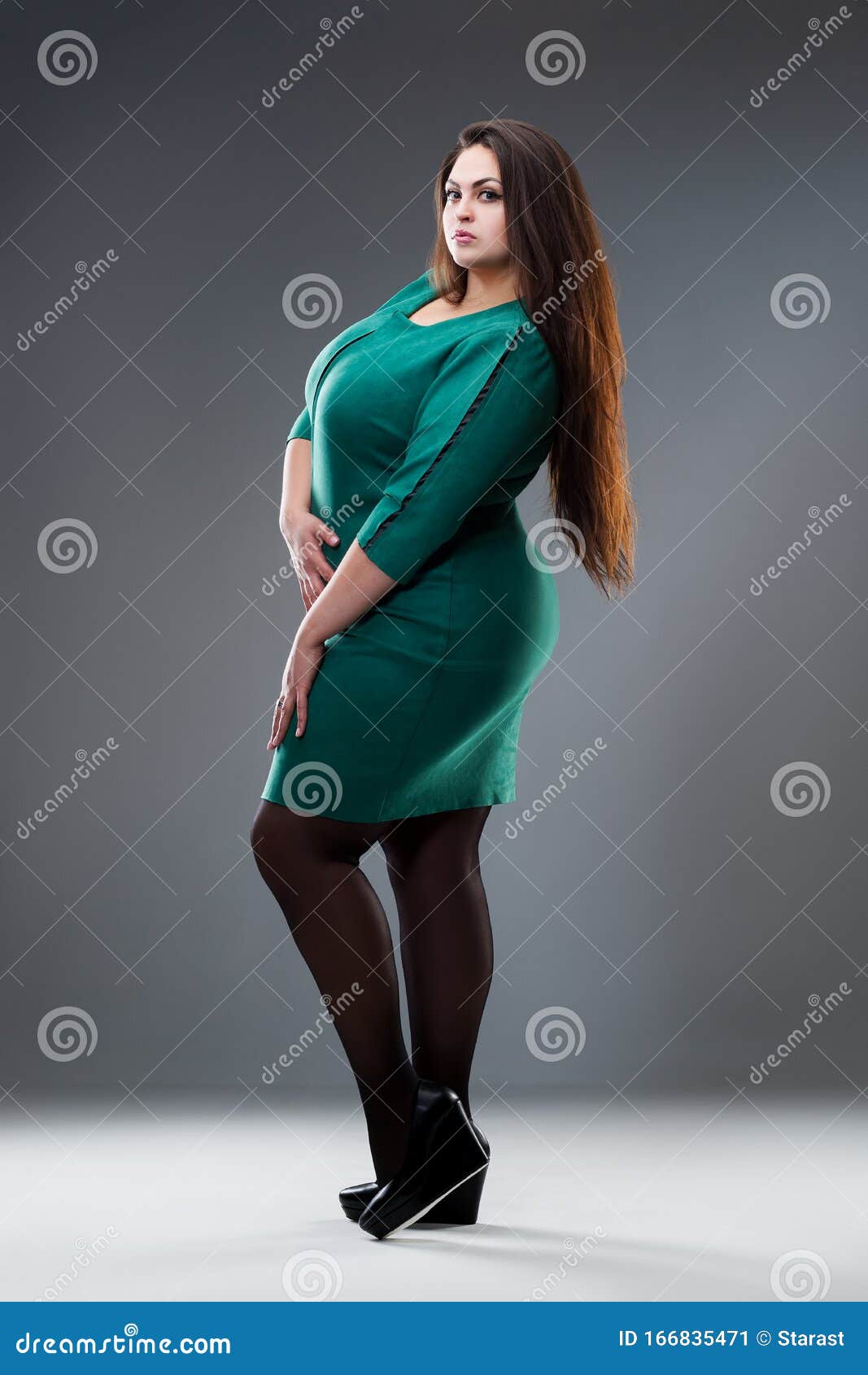 Plus Size Model In Green Dress Fat Woman With Long Hair On Gray Background Body Positive