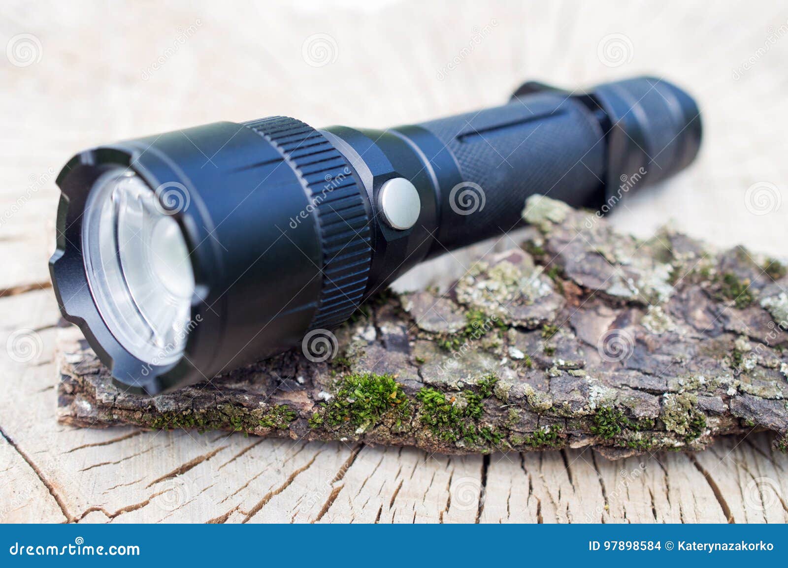 Pocket LED Flashlight Lies on a Tree Bark Stock Photo - Image of nature ...