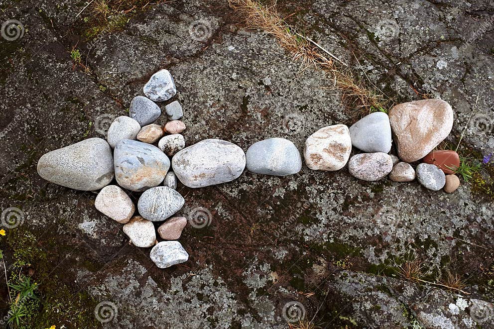 The Pointer Arrow is Made of Stones on a Granite Surface Close-up. the ...